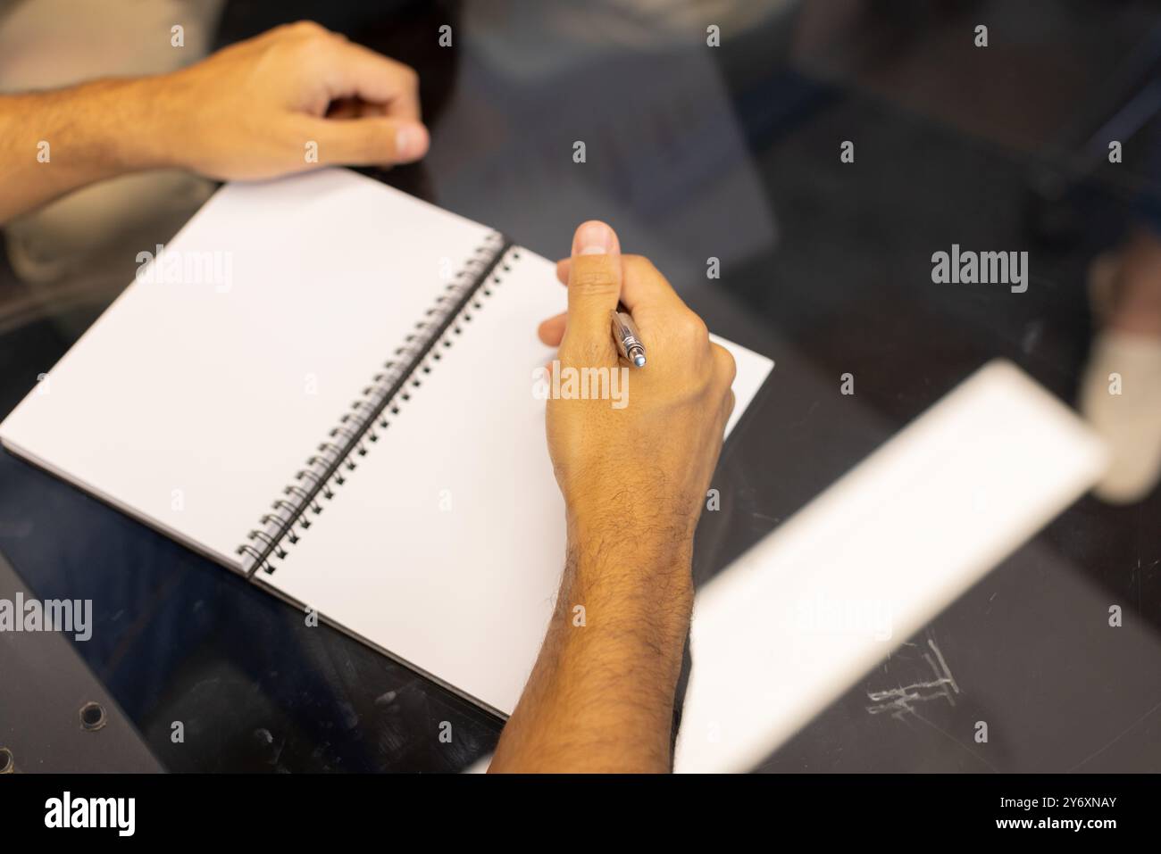 Writing in notepad, person taking notes during meeting at office desk ...