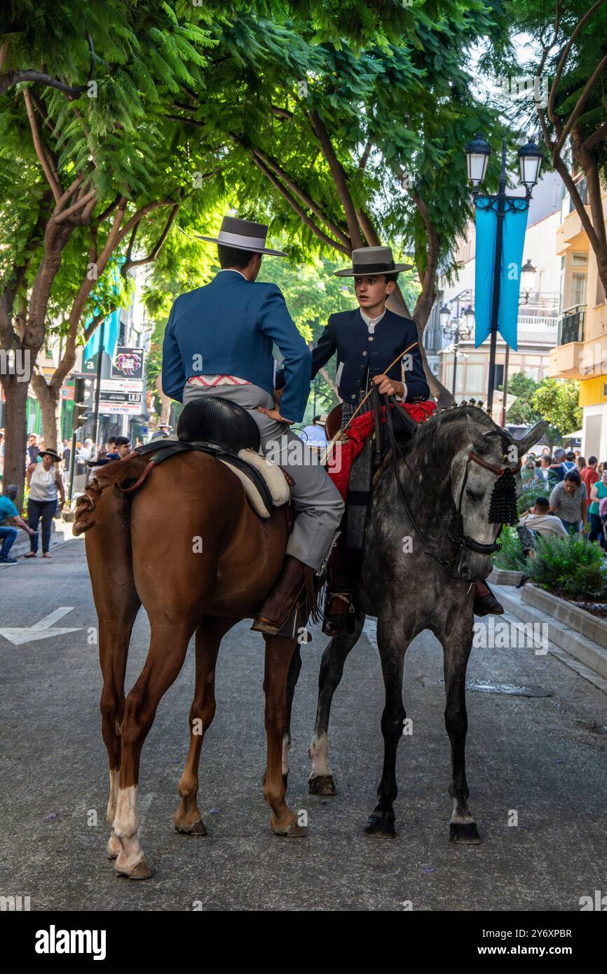 Group of riders dressed in traditional Andalusian costume, riding ...