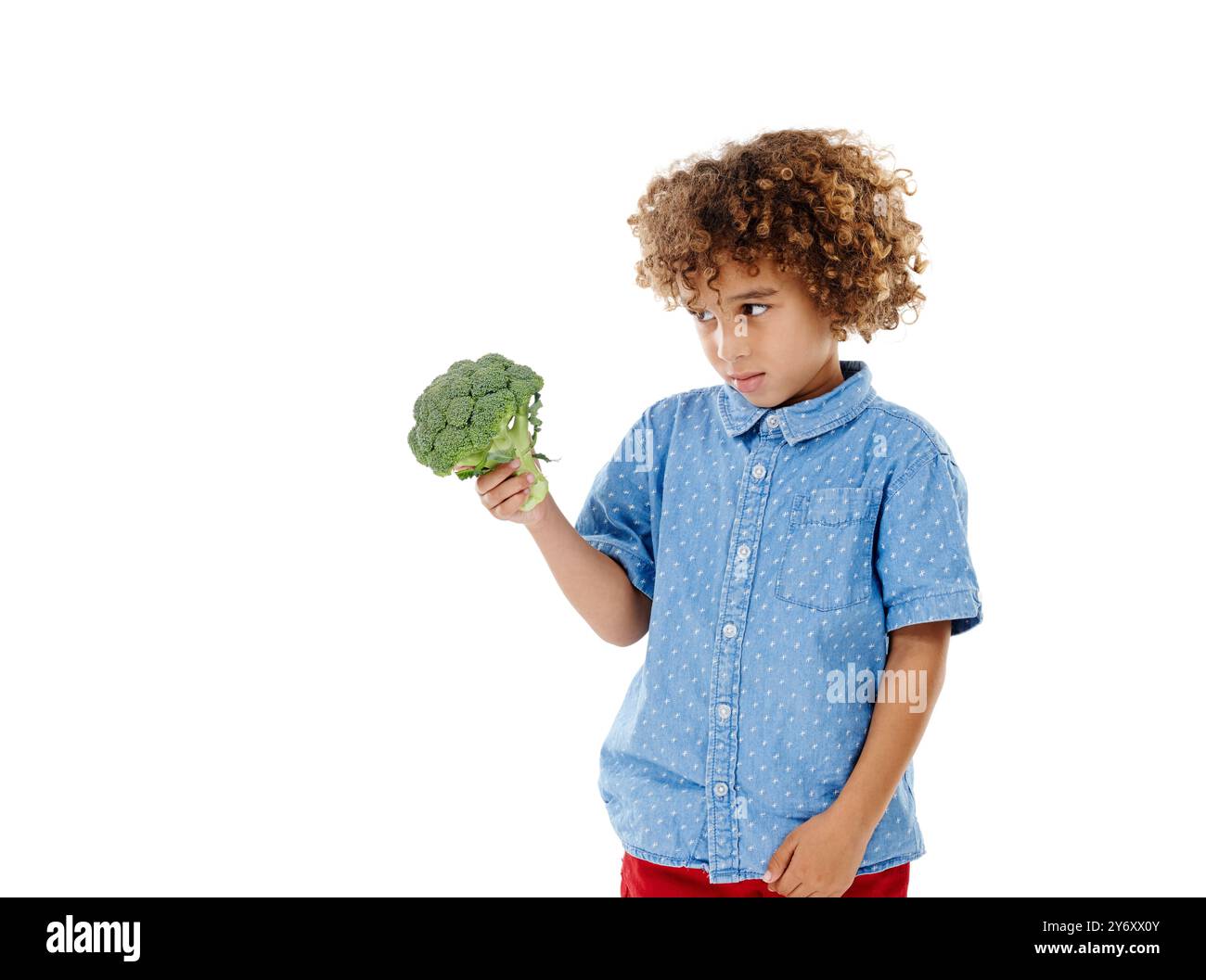 Boy, child and broccoli in studio with choice, disgust and confused ...
