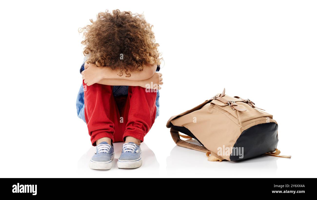 Crying, sad and child with backpack on a white background for ...