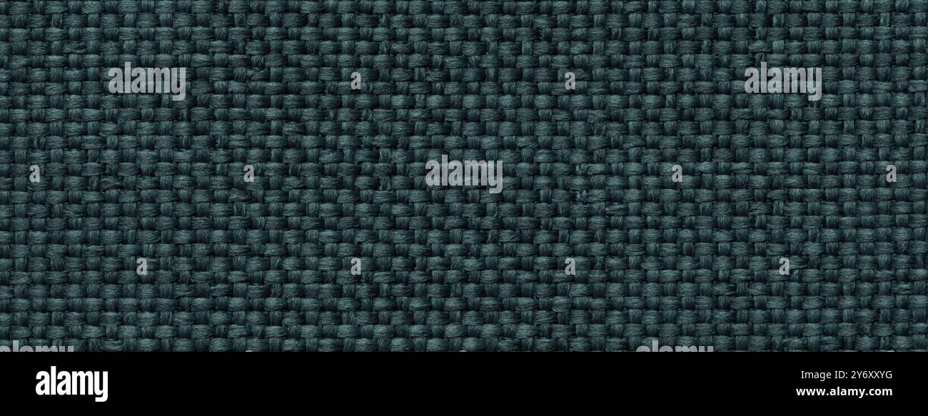 Dark green background with braided checkered pattern, closeup. Texture of the weaving fabric ...