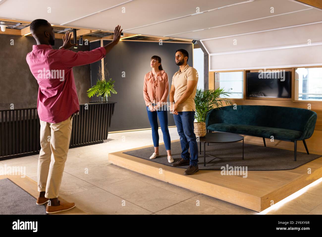 Leading discussion, man presenting to colleagues in modern office space ...