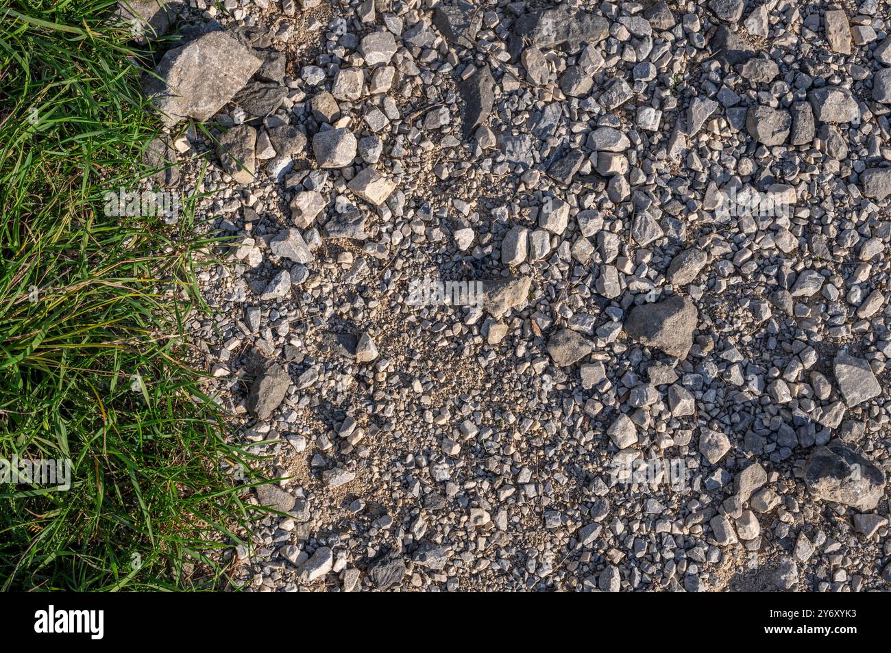 Textured Terrain: A Close-Up of Gravel and Grass Stock Photo - Alamy