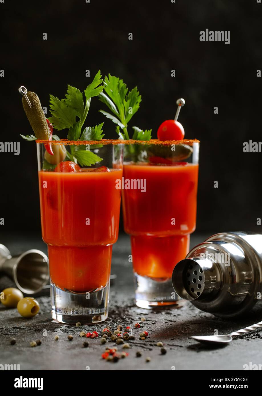 Glasses with bloody mary cocktail, cayenne pepper and spicy snacks on ...