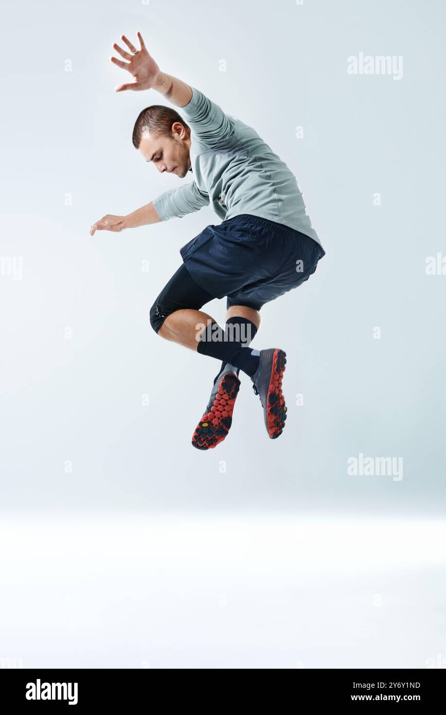 Fitness, man and jump with workout in studio for healthy body, exercise ...