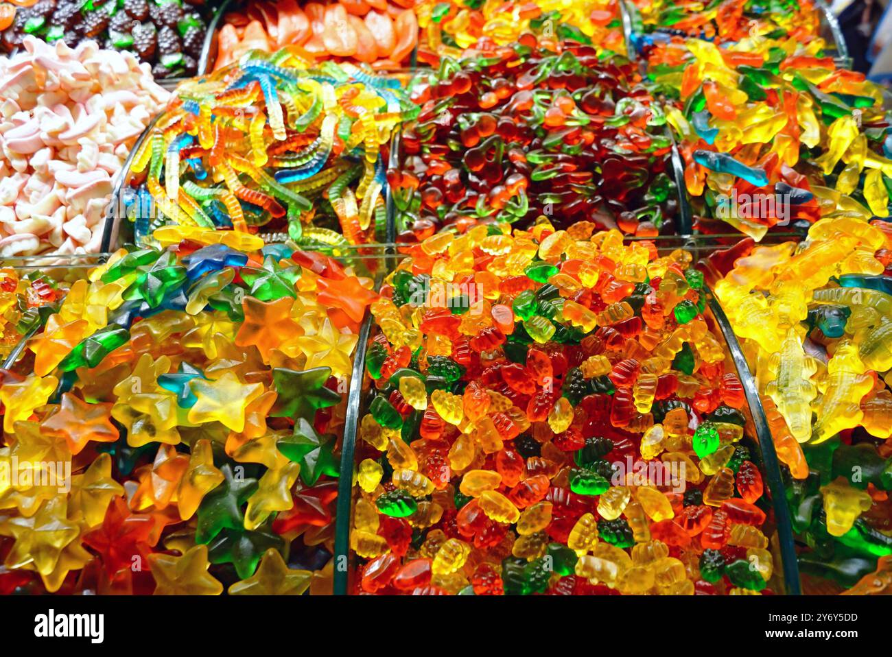 A stall with a wide range of gummy candies of different flavors and ...