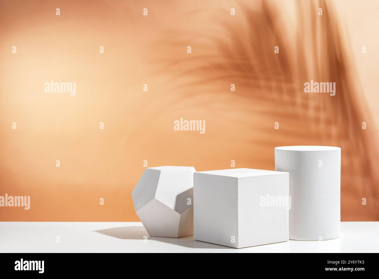 White geometric shapes arranged stylishly on a soft peach background in ...