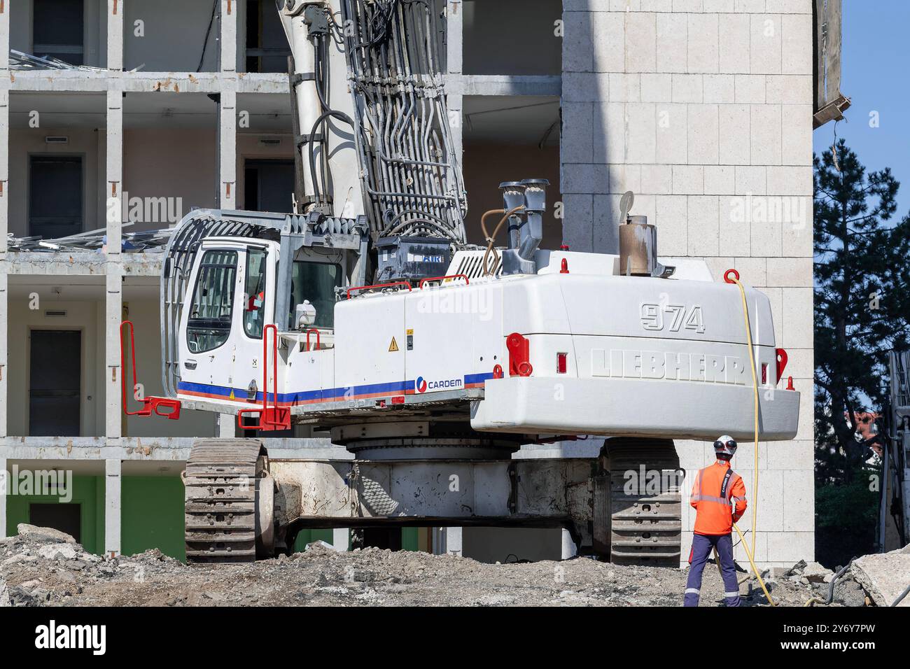 View on a white crawler excavator Liebherr R 974 C demolishing an ...