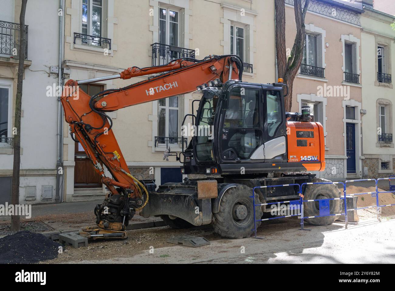 Nancy, France - View on an orange wheeled excavator Hitachi ZX145 W-6 ...