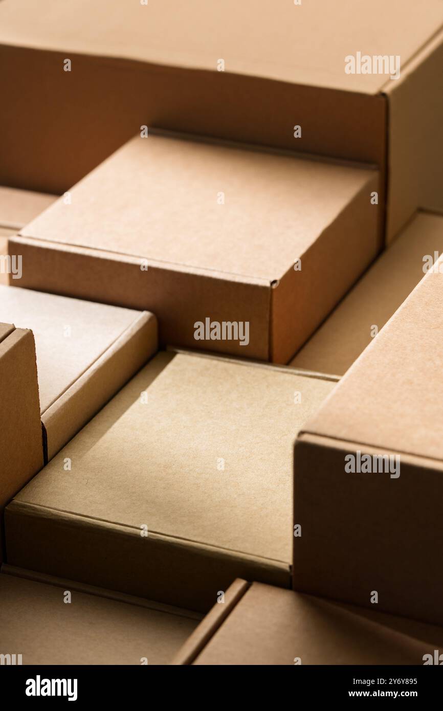 Stacked cardboard boxes arranged in a neat pattern under natural light ...
