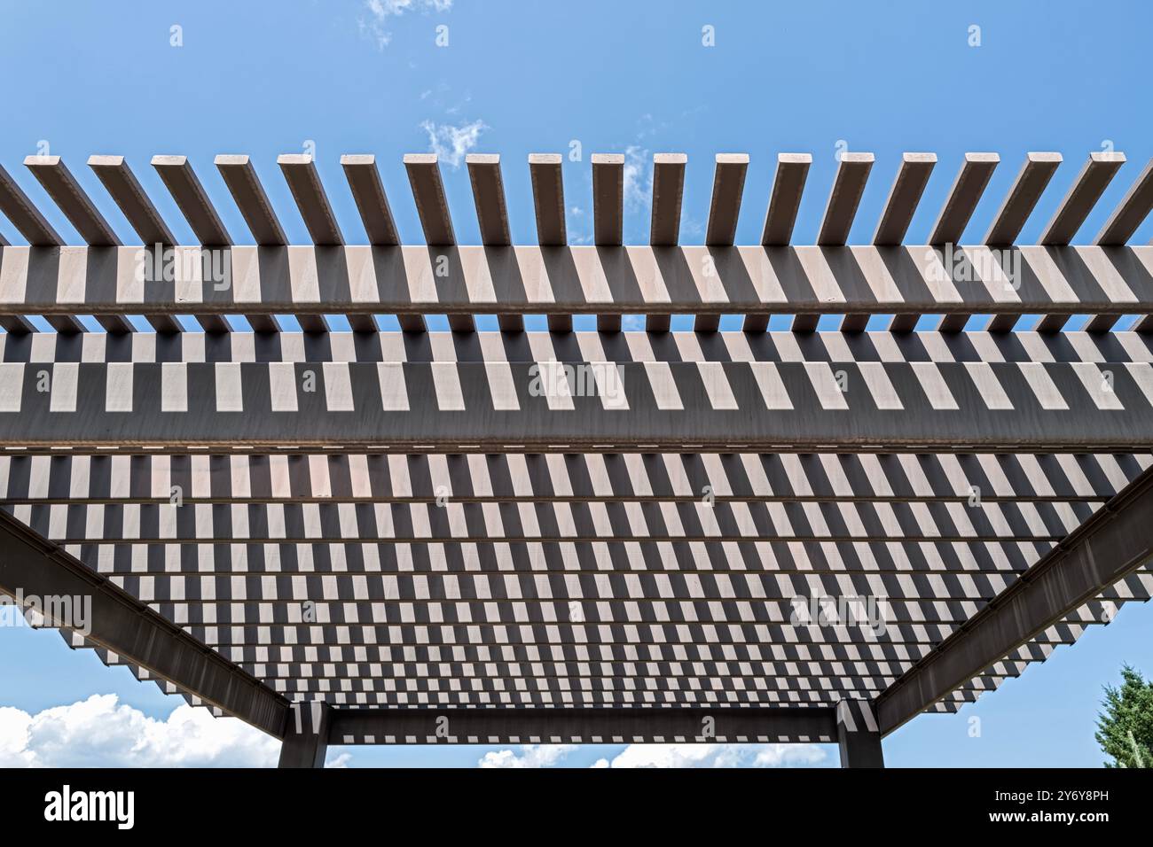 Shadow patterns falling across a white pergola under a blue sky Stock ...