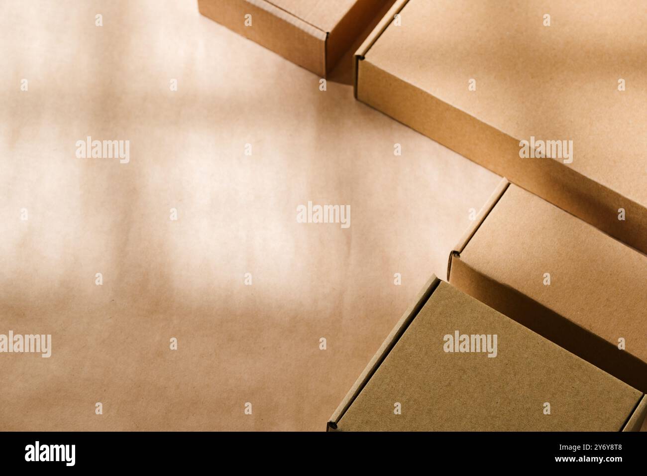 Brown cardboard boxes arranged on a neutral background in a warehouse ...