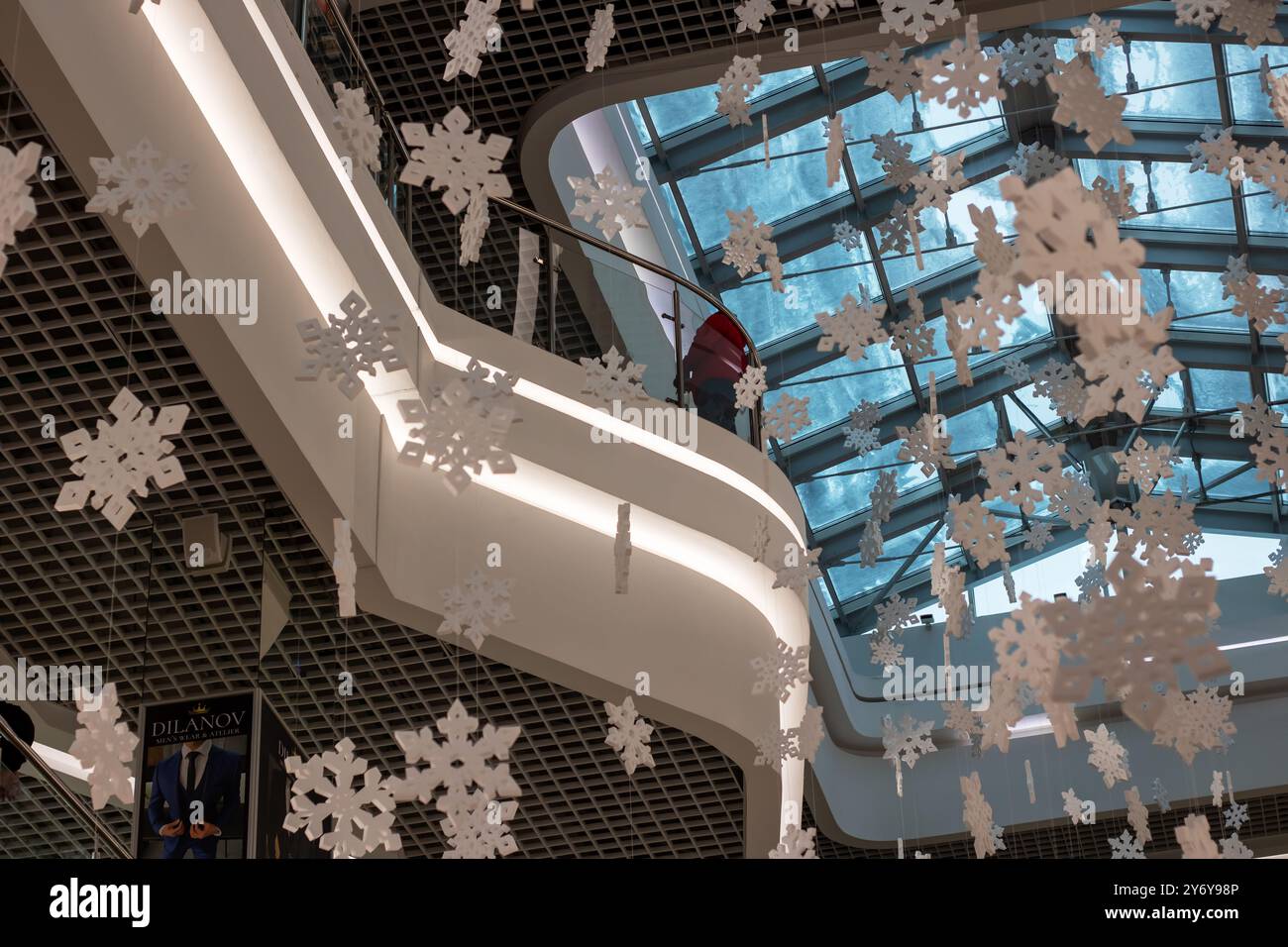 Delicate snowflakes are gracefully hanging down from the ceiling of a ...