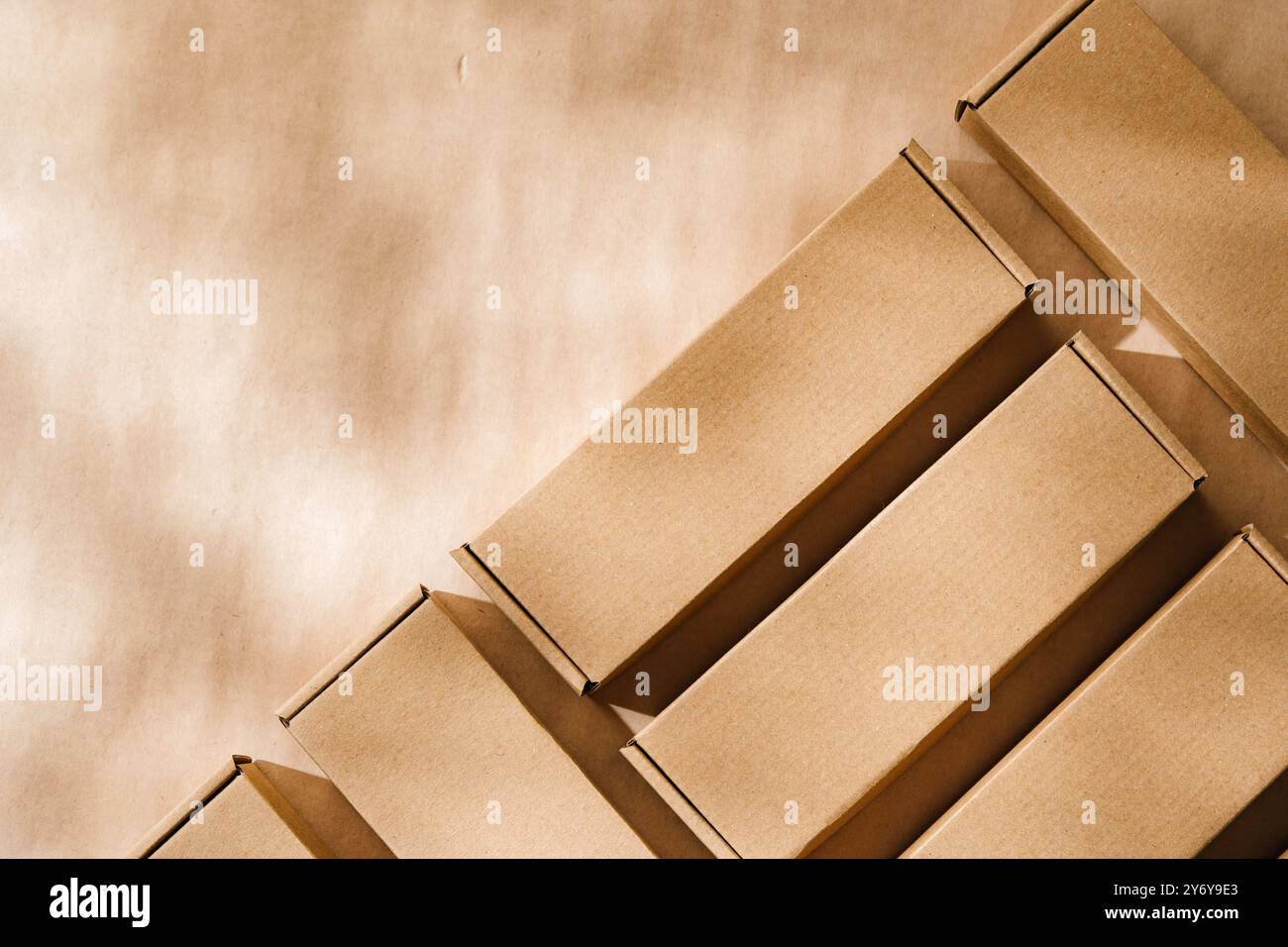Brown cardboard boxes arranged on a neutral background in a warehouse ...