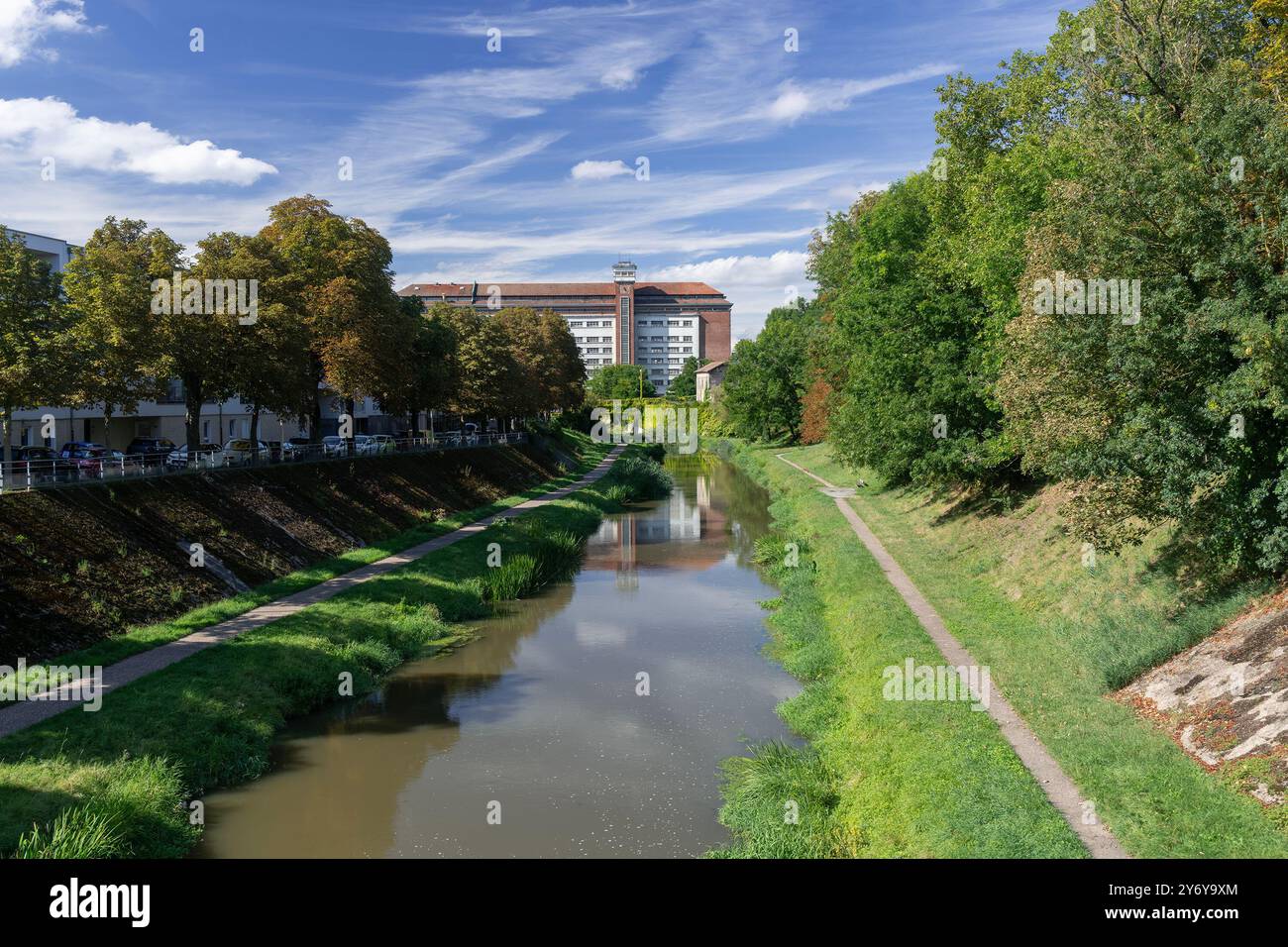 Nancy - View on an old building of the mills of Nancy behind trees ...