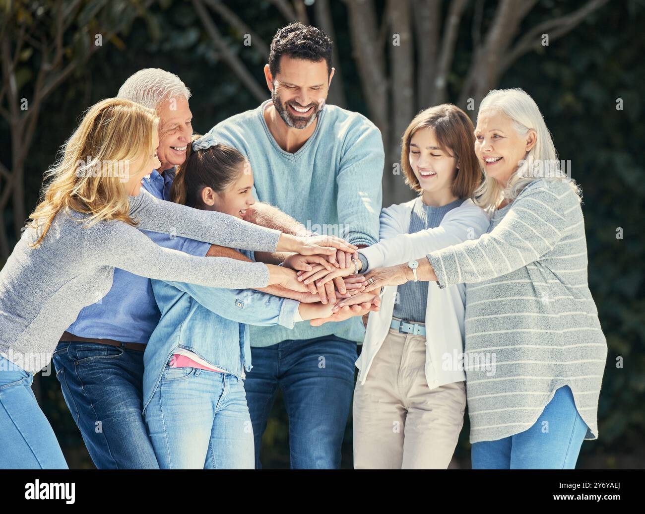 Stack of hands, nature and family generations with unity, support and synergy for commitment ...