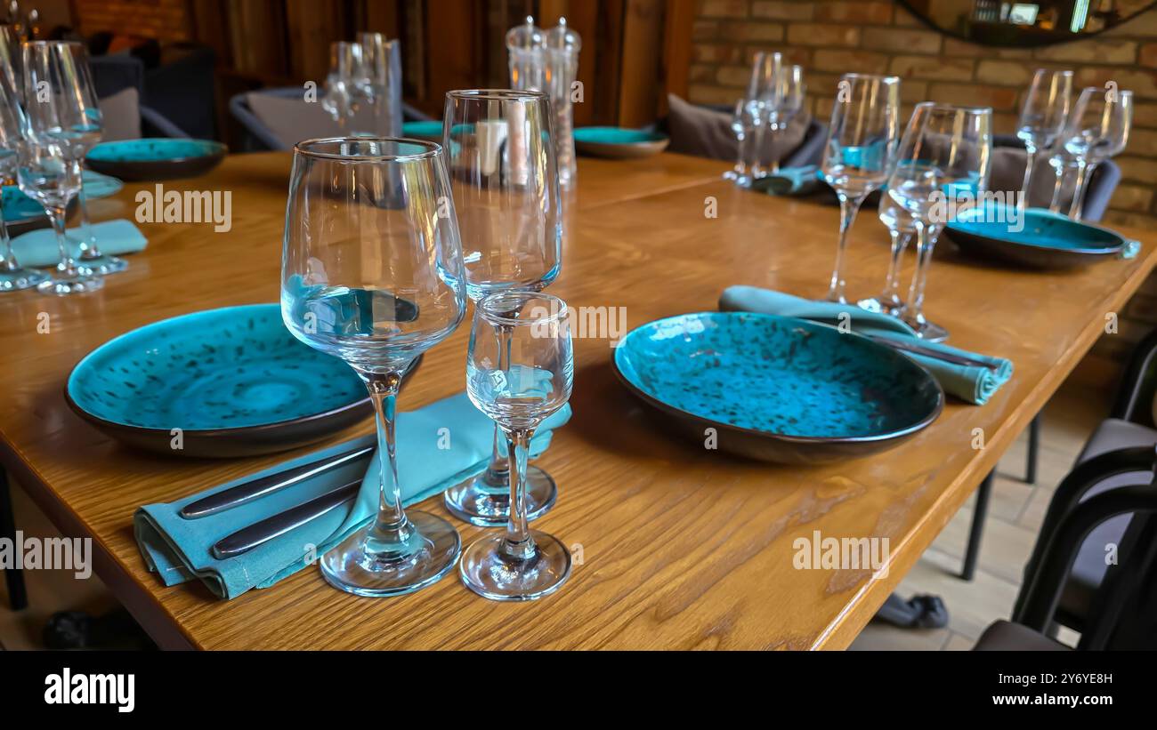 Interior in a city restaurant. Preparation for a buffet. Dishes and ...