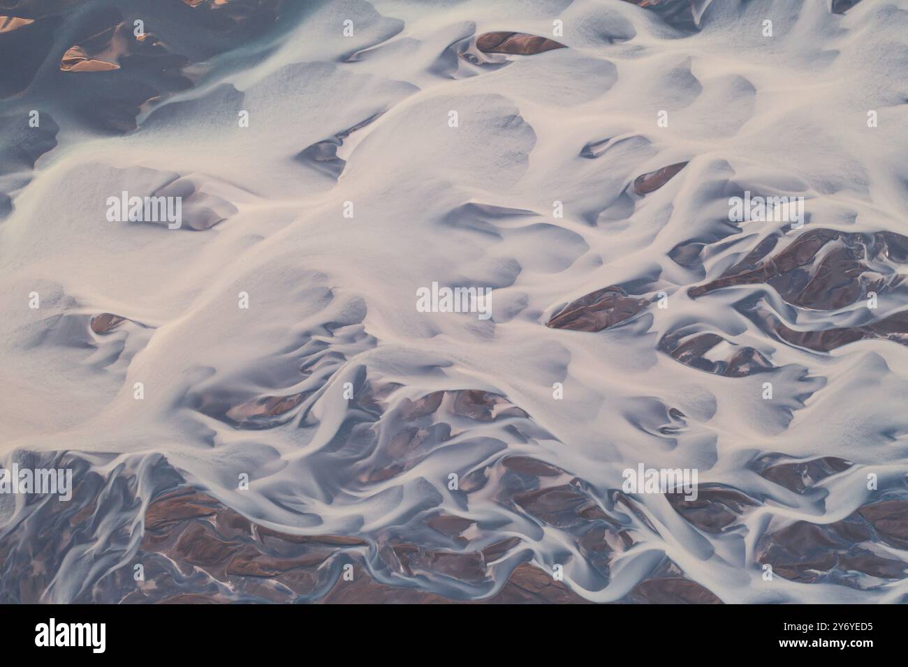 Aerial view of intricate patterns formed by winding river channels and ...