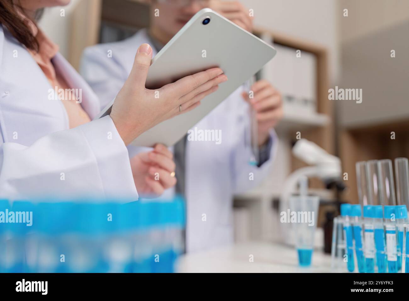 Research Scientist Using Tablet for Data Collection in Chemistry Lab ...
