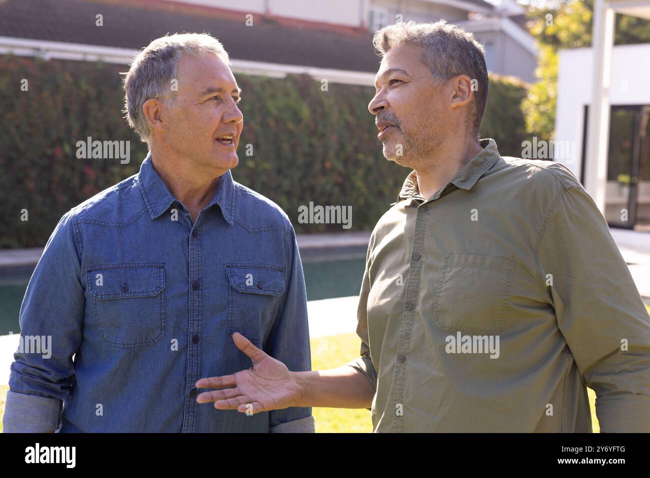 Talking and smiling, two senior diverse friends enjoying outdoor ...