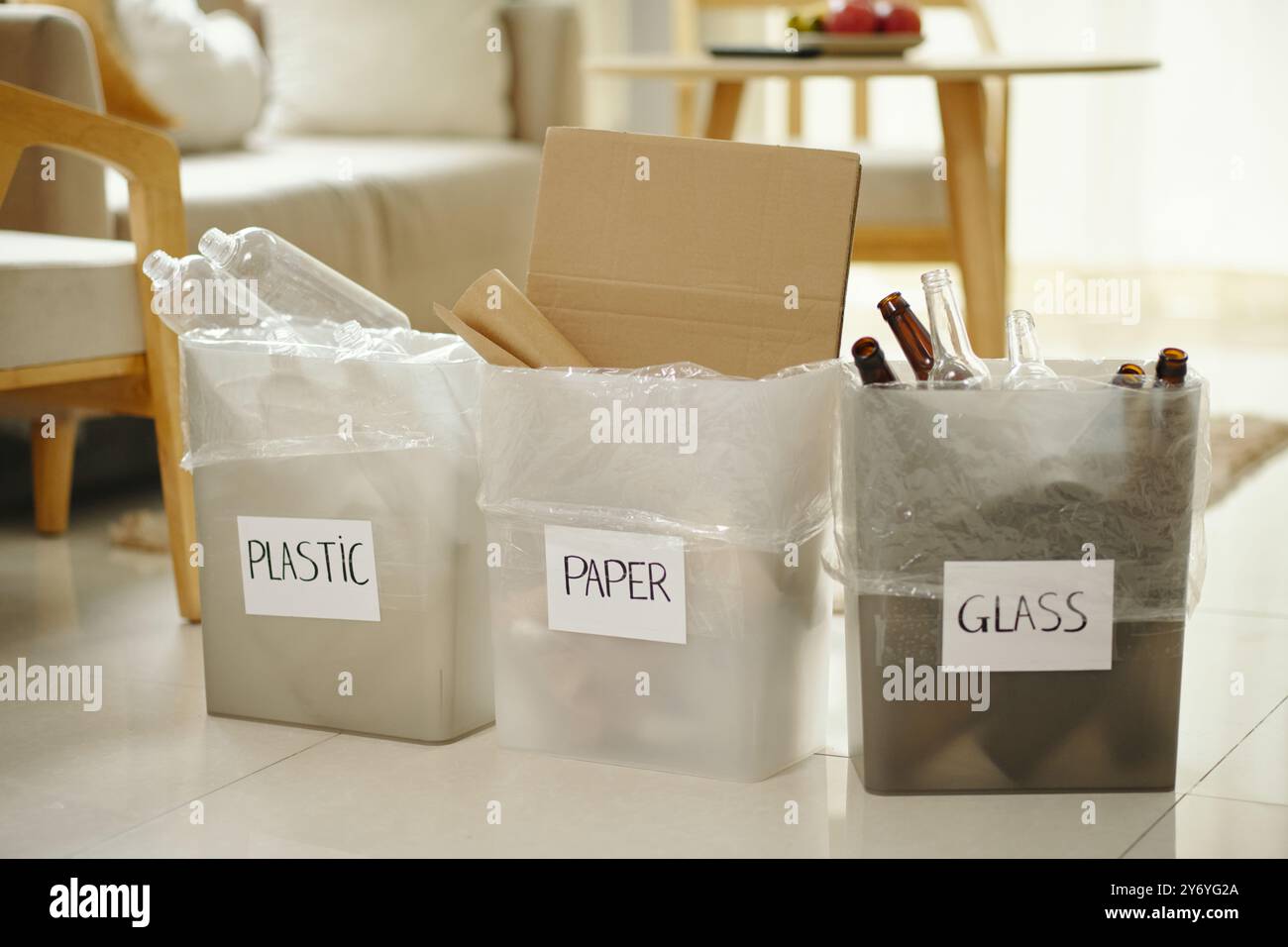 Sorting Recyclable Waste into Plastic Paper Glass Bins Stock Photo - Alamy