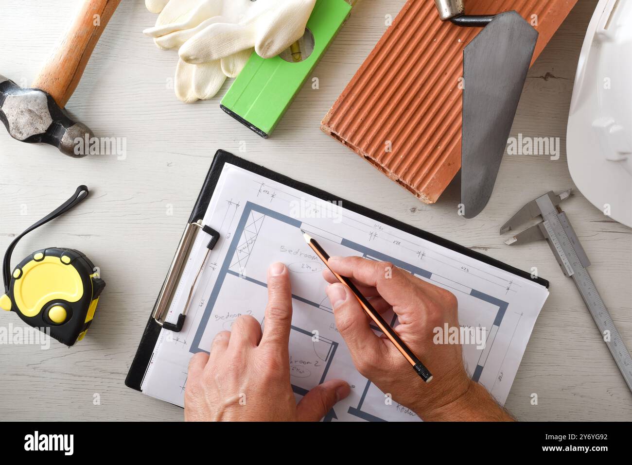 Architect taking notes on house plan on white wooden table with ...