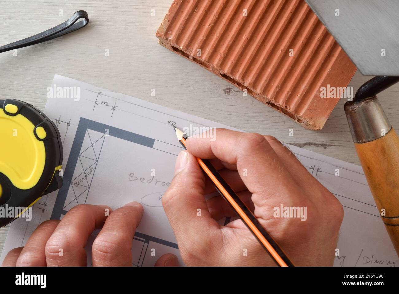 Detail of architect noting on house plan on white wooden table with ...