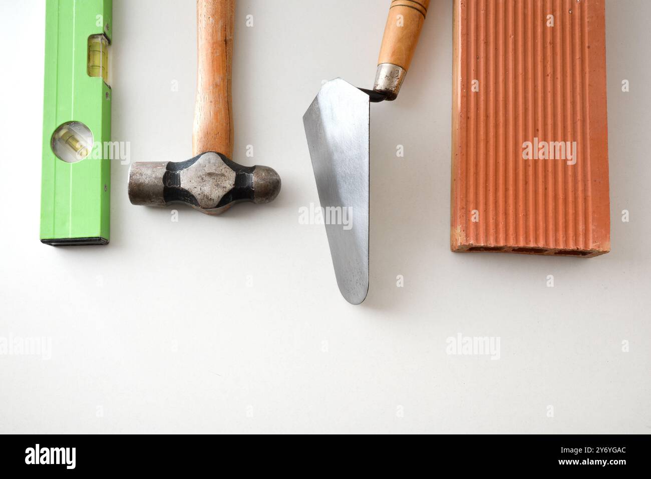 Construction tools such as trowel, level, hammer and brick isolated on ...
