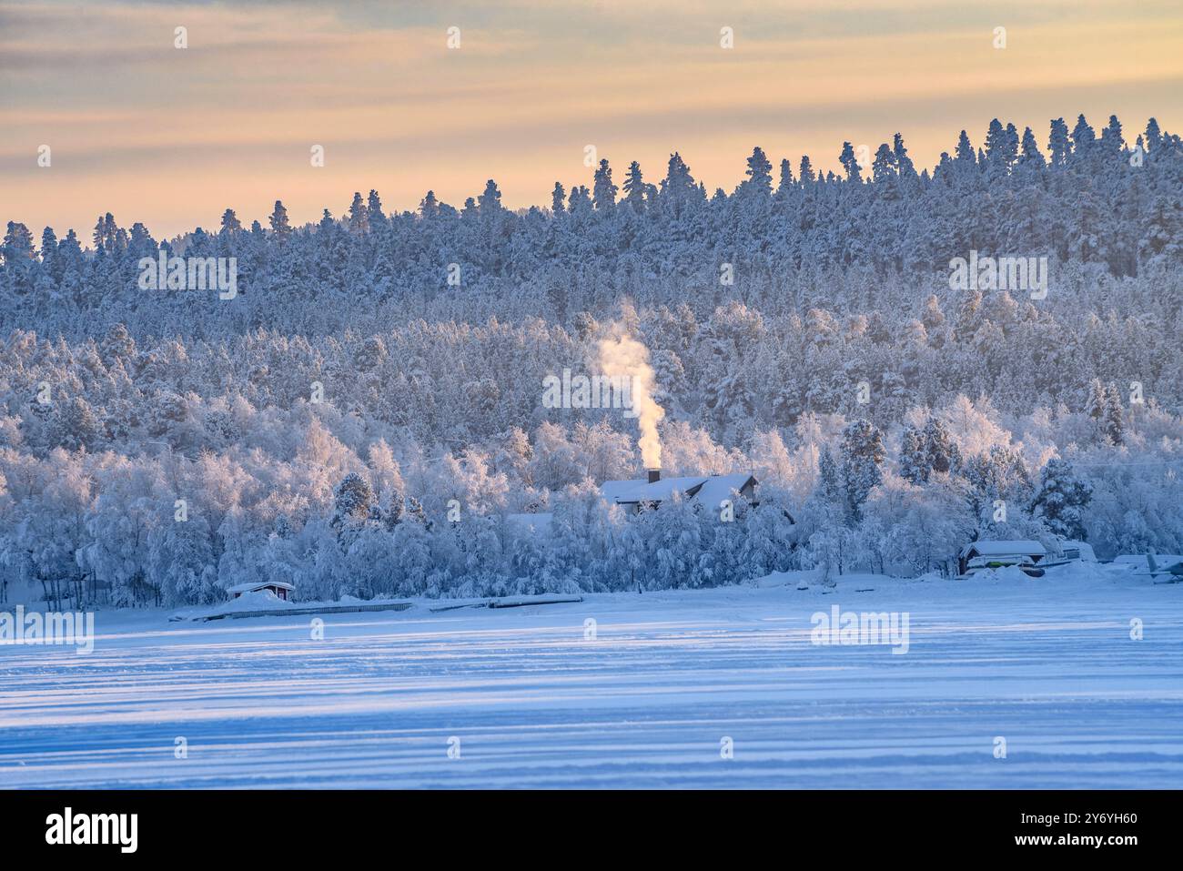 Frozen and snowy Lake Inari in winter, seen at sunset (Lapland, Finland ...