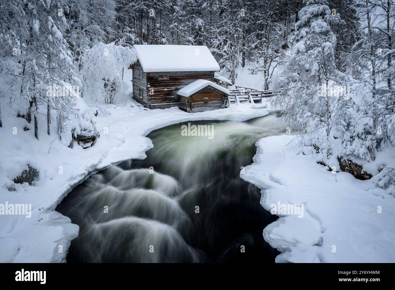 Old Myllykoski mill, covered in snow in winter, next to the rapids of ...