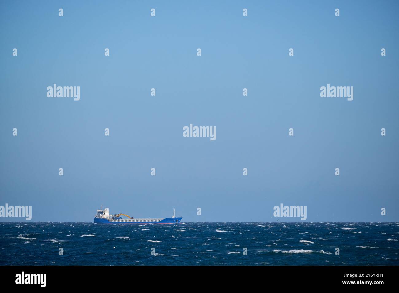 Ship sailing on deep seawater against blue sky Stock Photo - Alamy