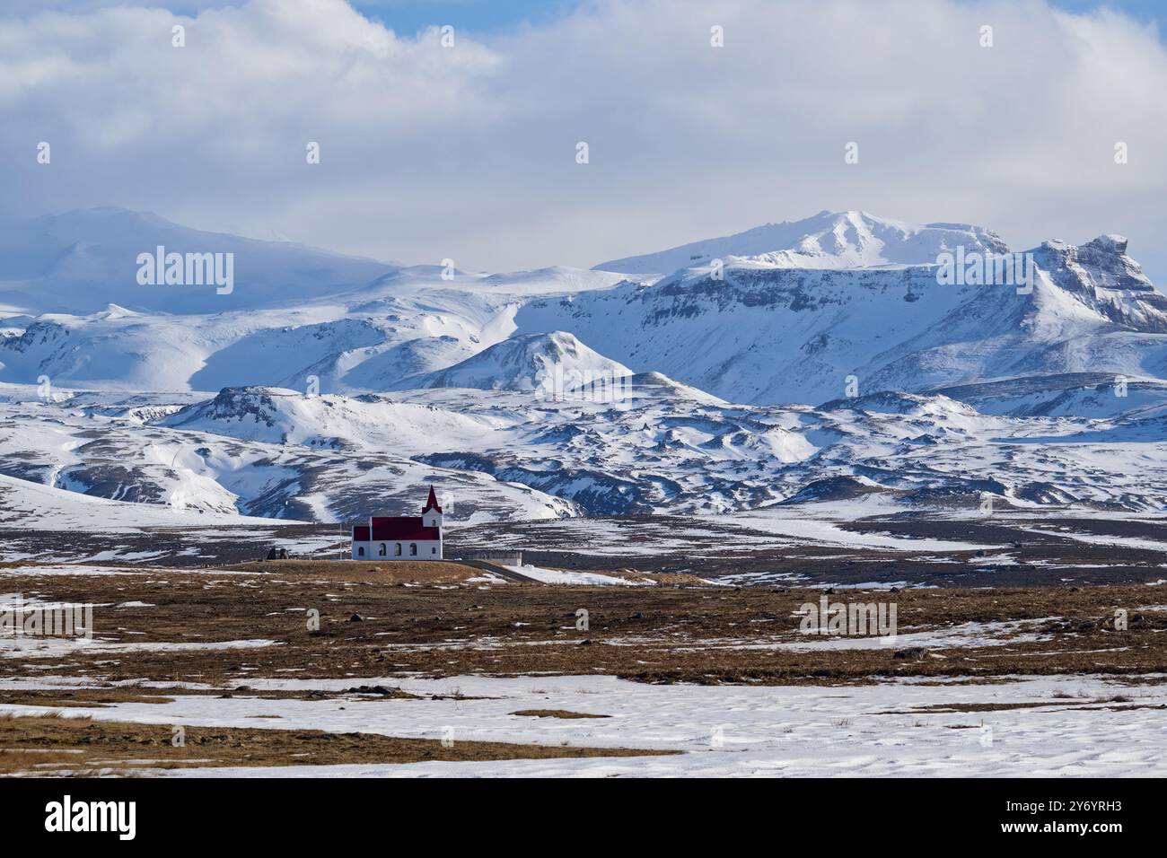 Lonely building in snowy landscape under cloudy sky Stock Photo - Alamy