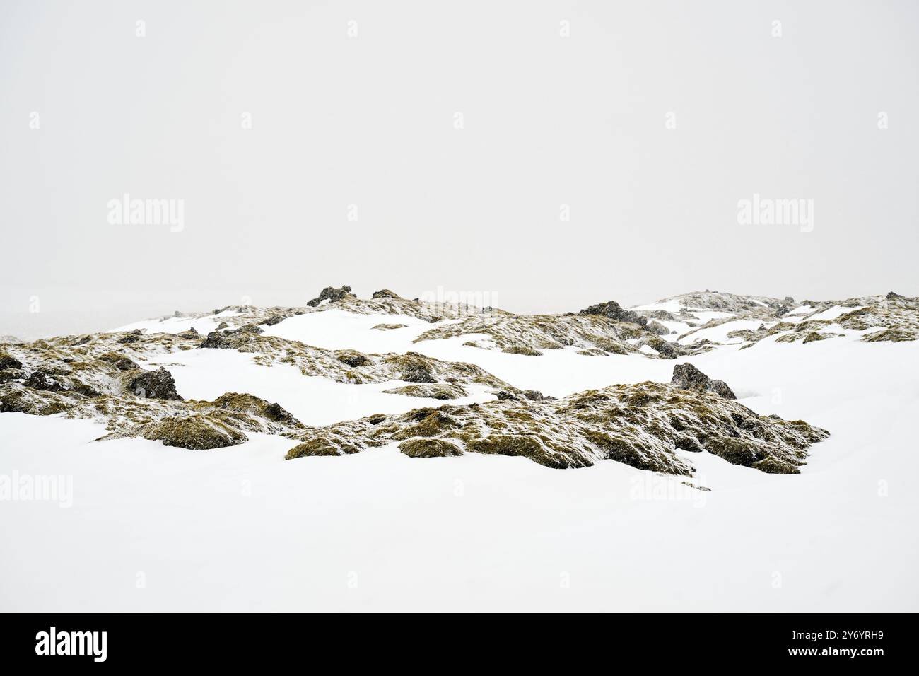 Rocky terrain covered in ice during snowfall Stock Photo - Alamy