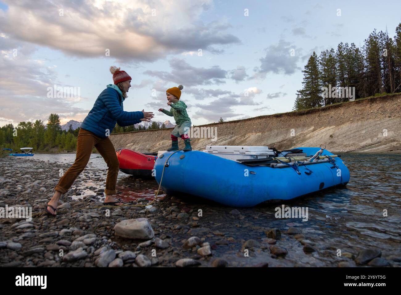 A mother catches her jumping child during a rafting trip Stock Photo ...