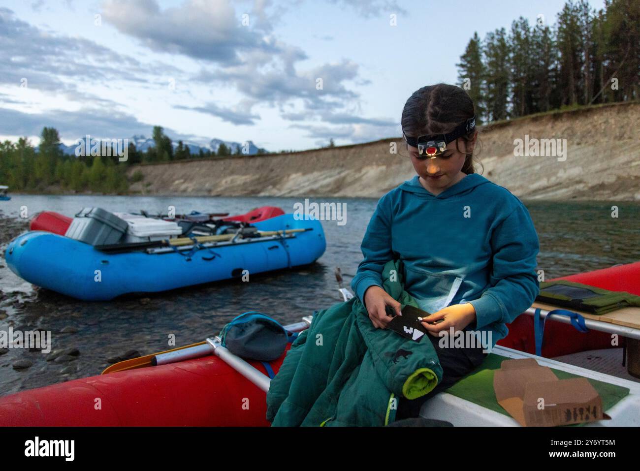 A young girl sits on her raft during a camping trip Stock Photo - Alamy