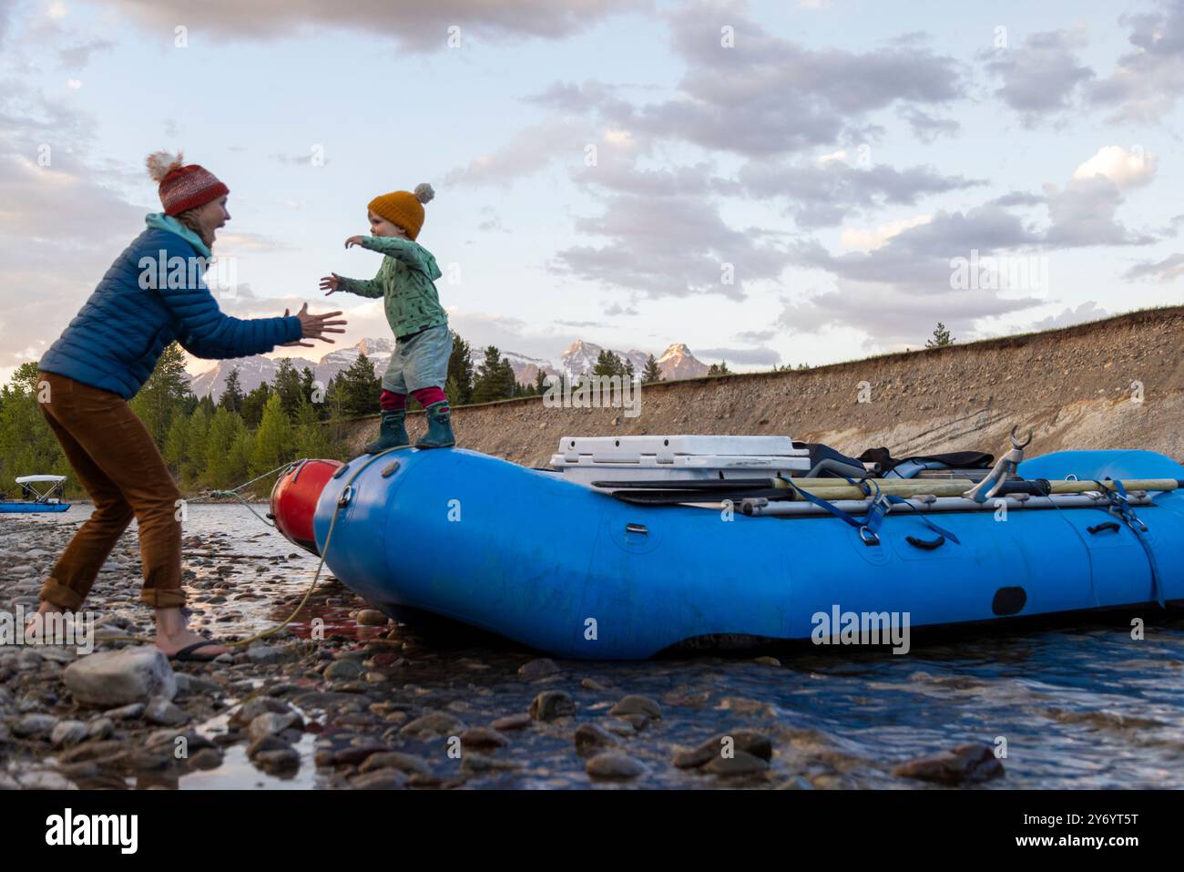 A young boy jumps off the front of a raft while camping Stock Photo - Alamy
