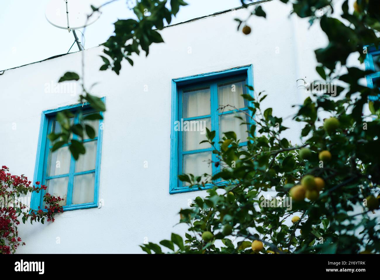 Charming Mediterranean Home with Blue Windows Stock Photo - Alamy