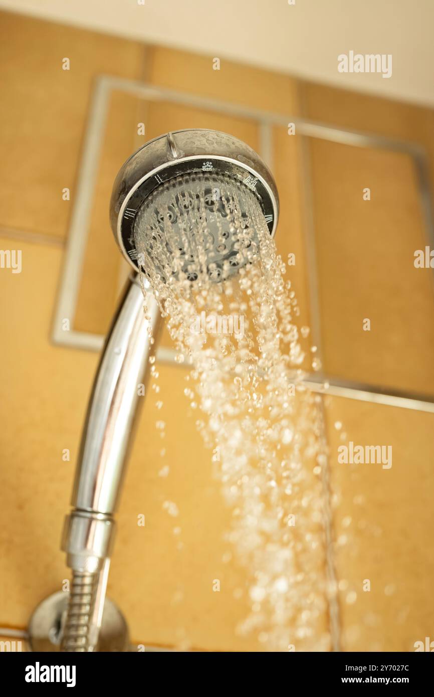 Shower head with running water. High shutter speed capture of water ...