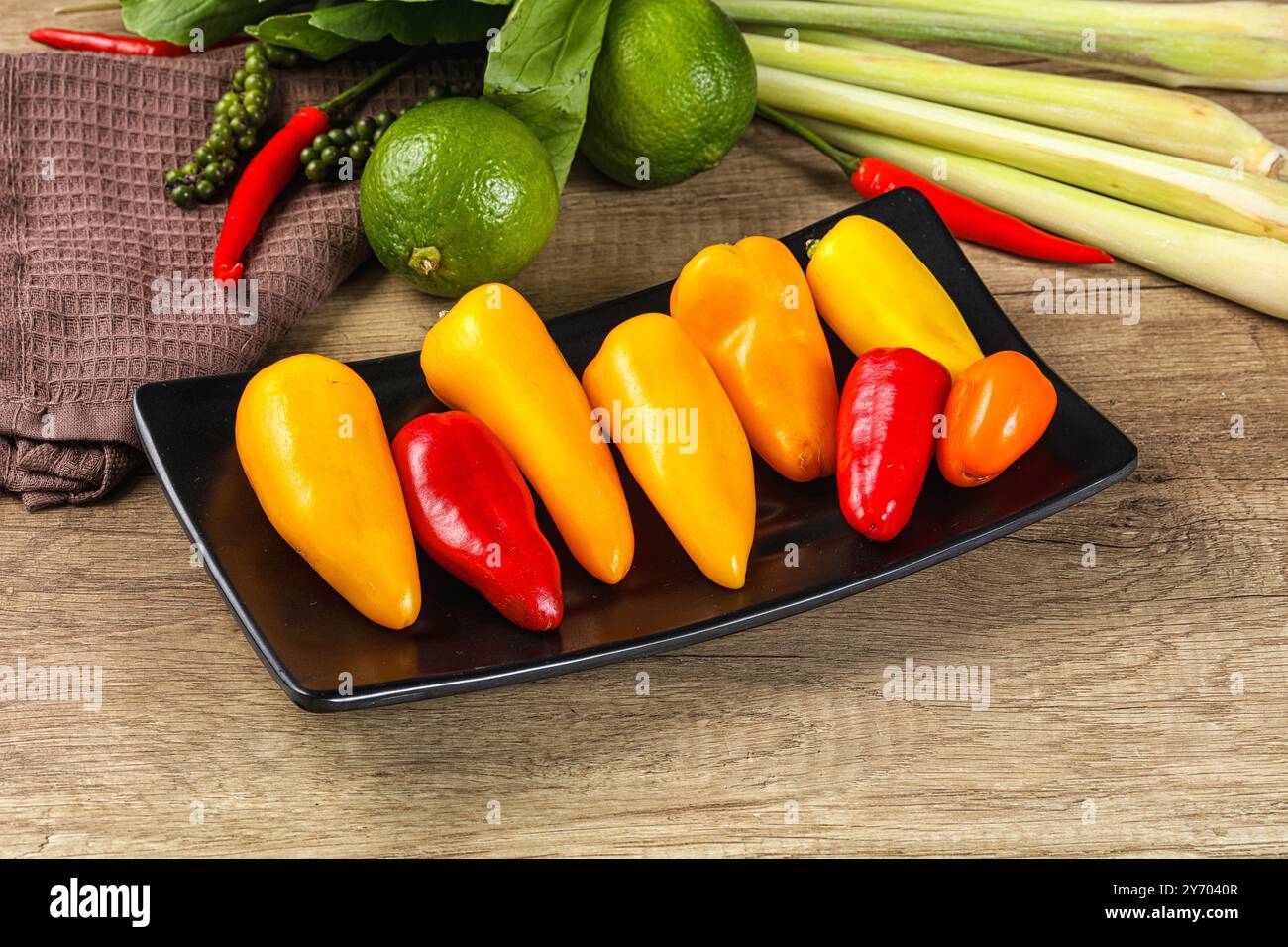 Small baby red and yellow bell pepper heap Stock Photo - Alamy