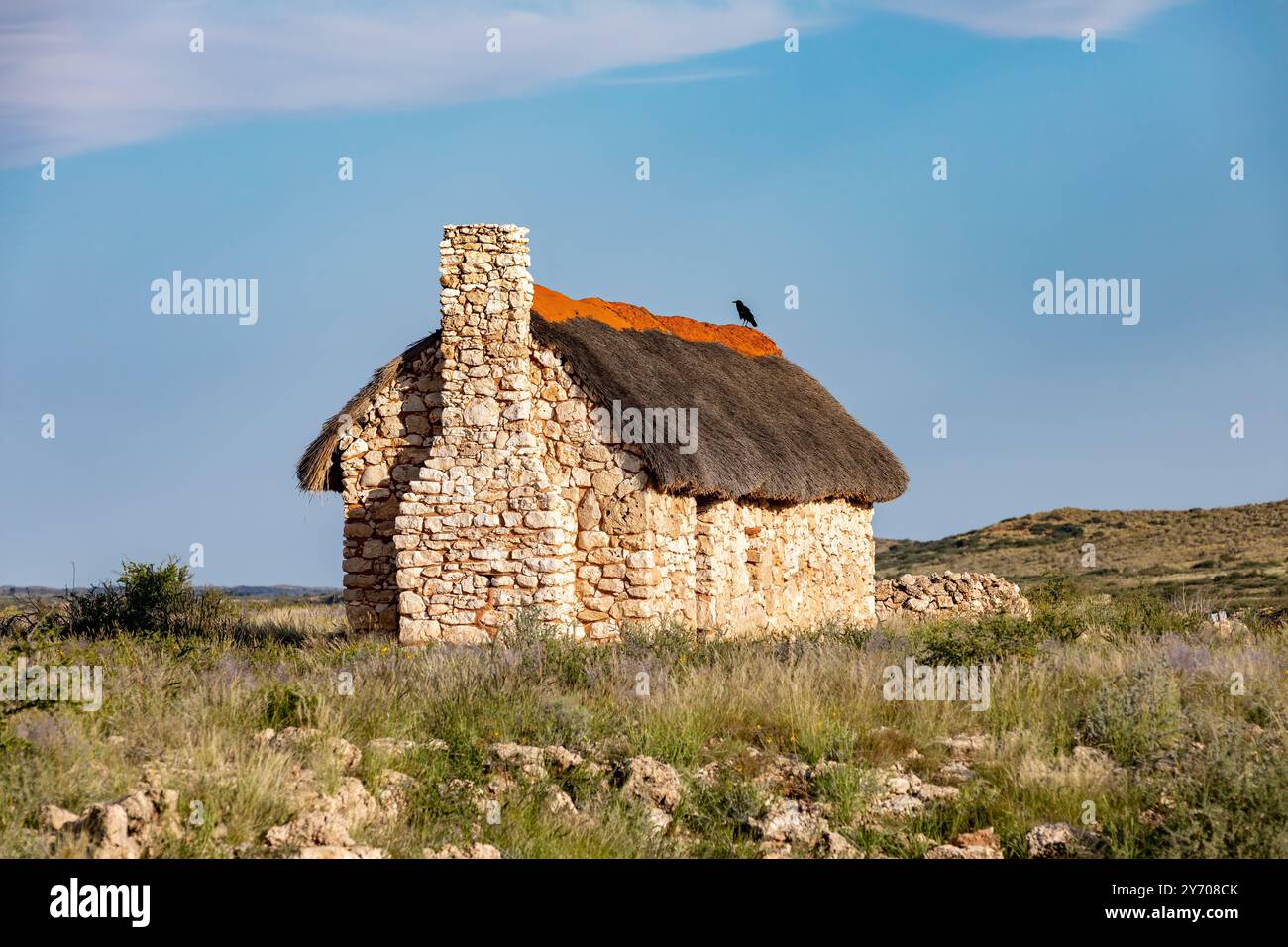 Alone stone house, weathered by the harsh elements, sits amidst the ...