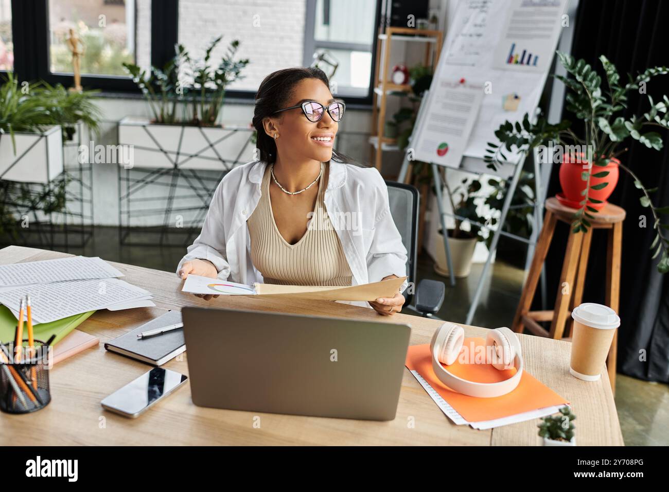 A young professional in an inviting office environment engages with her ...