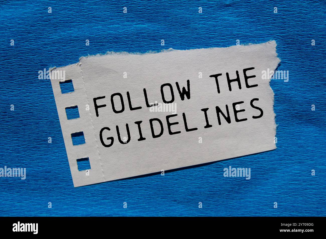 Follow the guidelines message written on ripped torn paper piece with ...