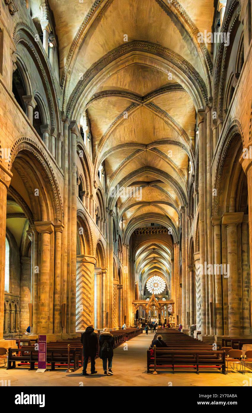 The nave and central aisle of Durham Cathedral, with its decorative ...