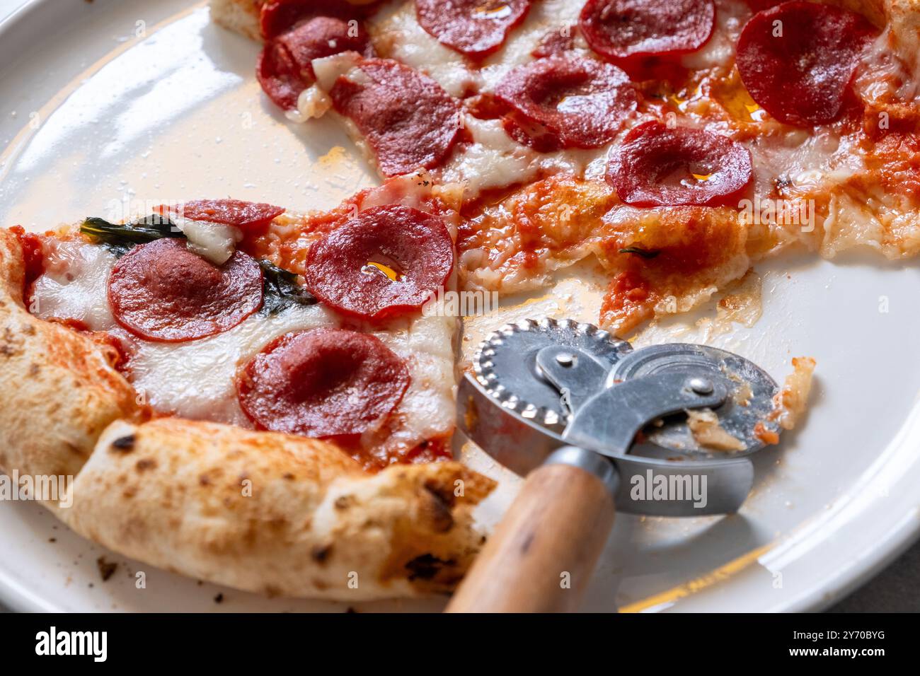 Traditional homemade Italian pizza baked on a black baking tray Stock ...