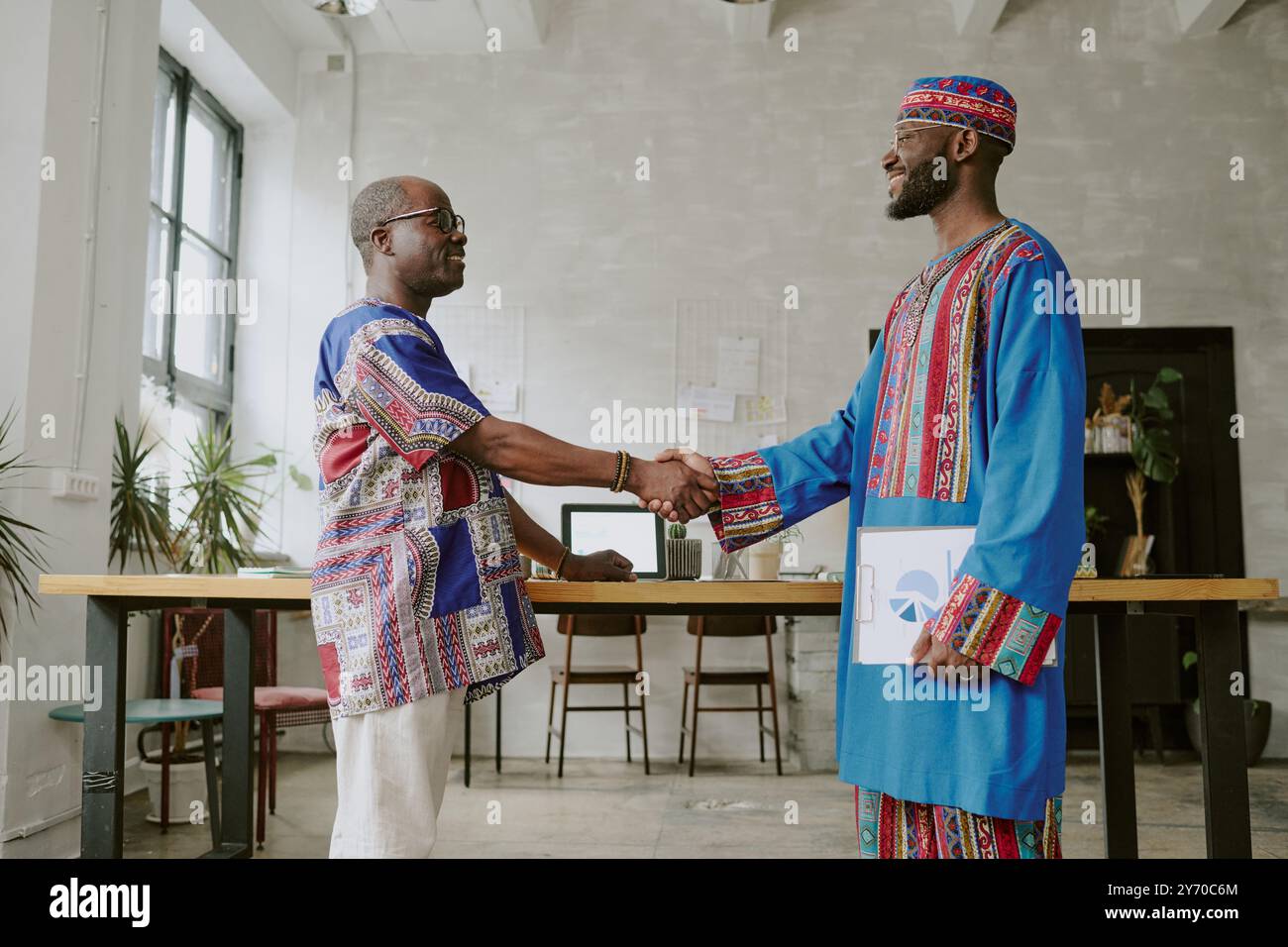 Low angle shot of African American coworkers in traditional costumes ...