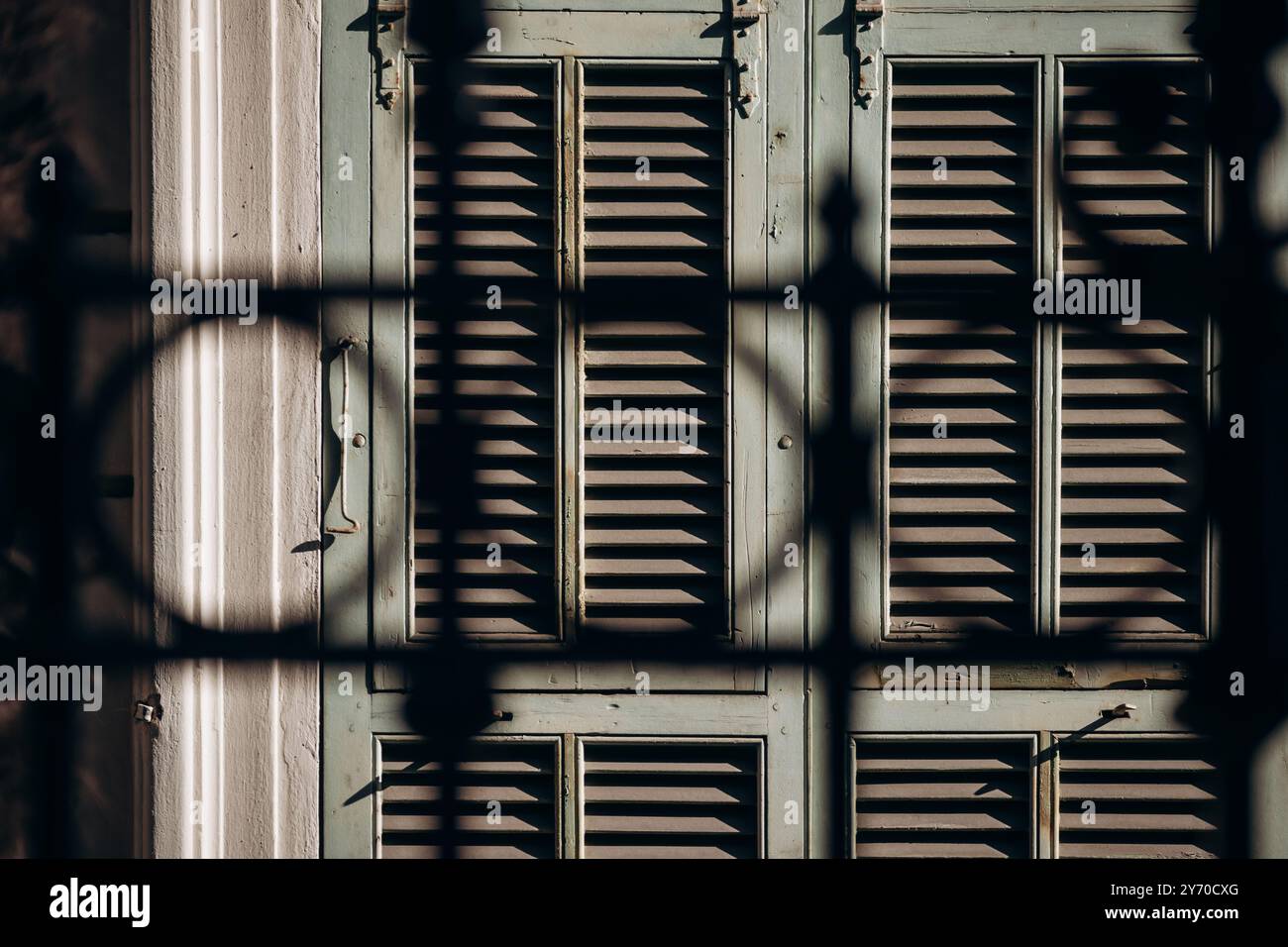 Traditional green shutters in Nice through wrought iron lattice Stock ...