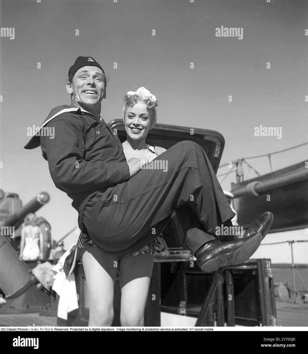 During World war II. A strong young woman is seen lifting a sailor and ...
