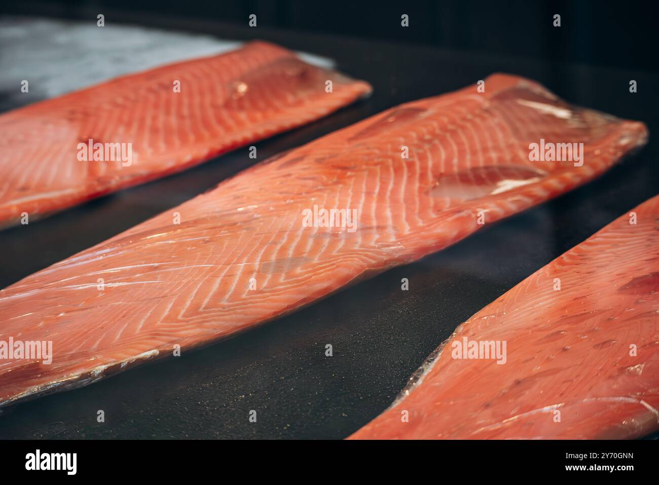Cut fresh salmon in a fishmonger's display case Stock Photo - Alamy