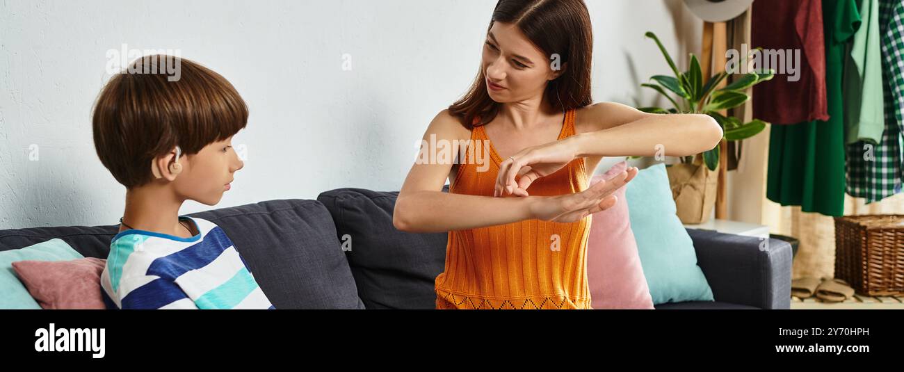 A mother lovingly teaches her hearing impaired son to communicate ...