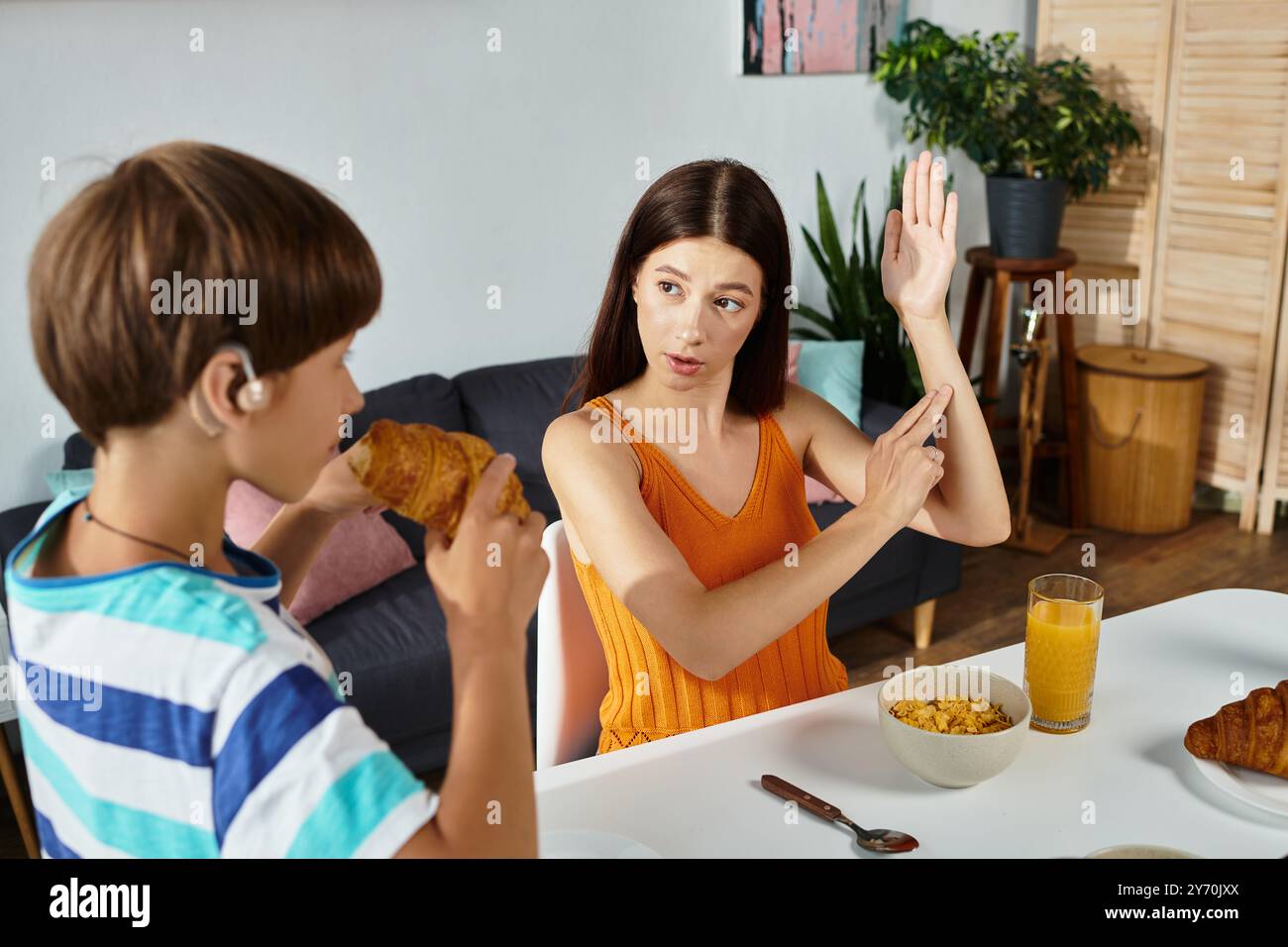 The mother engages her son in learning sign language while they enjoy ...